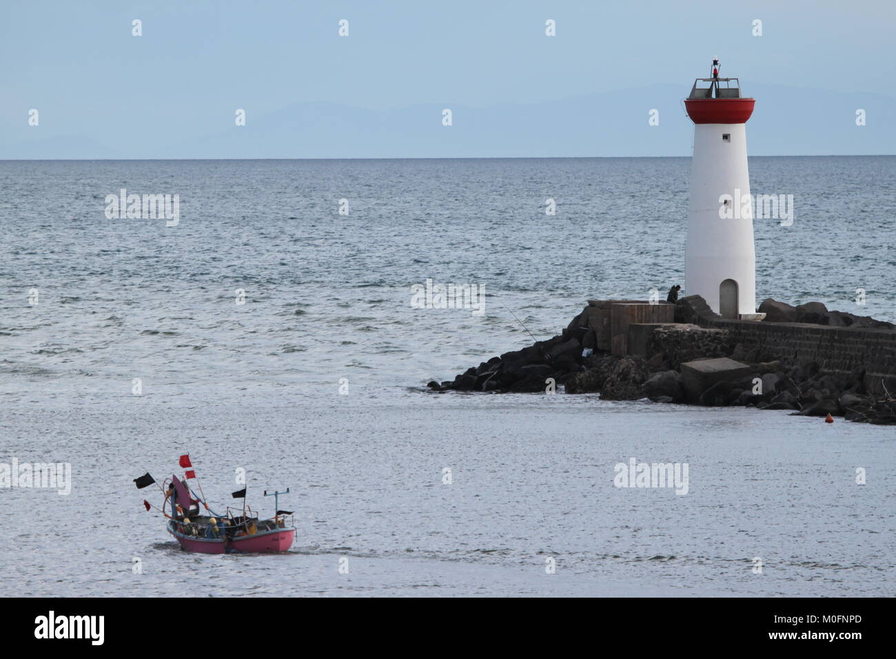 Boat passing Lighthouse Stock Photo - Alamy