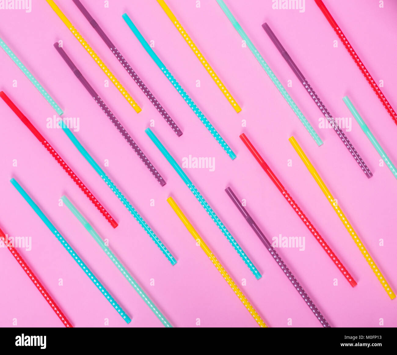colorful plastic tube with white polka dots for drinks scattered on a ...