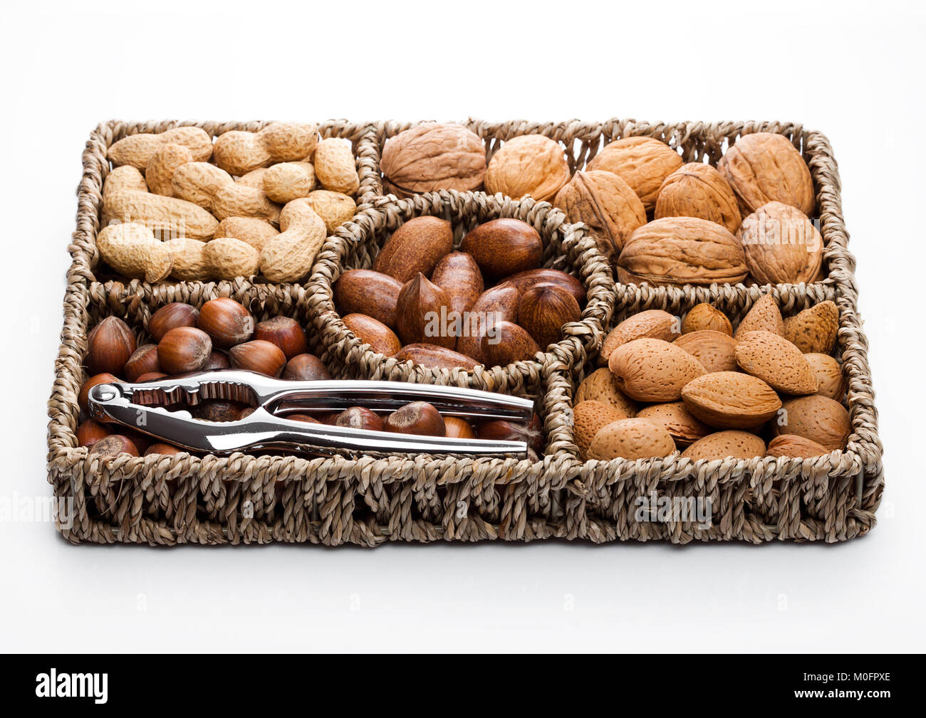 Basket reach in various kinds of nuts in shells, pecans, almonds ...