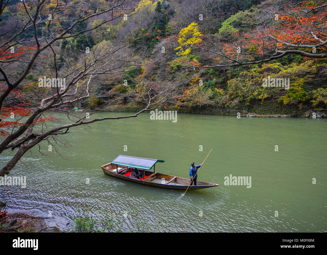 Kyoto, Japan - Nov 28, 2016. A man rowing boat on river at Arashiyama ...