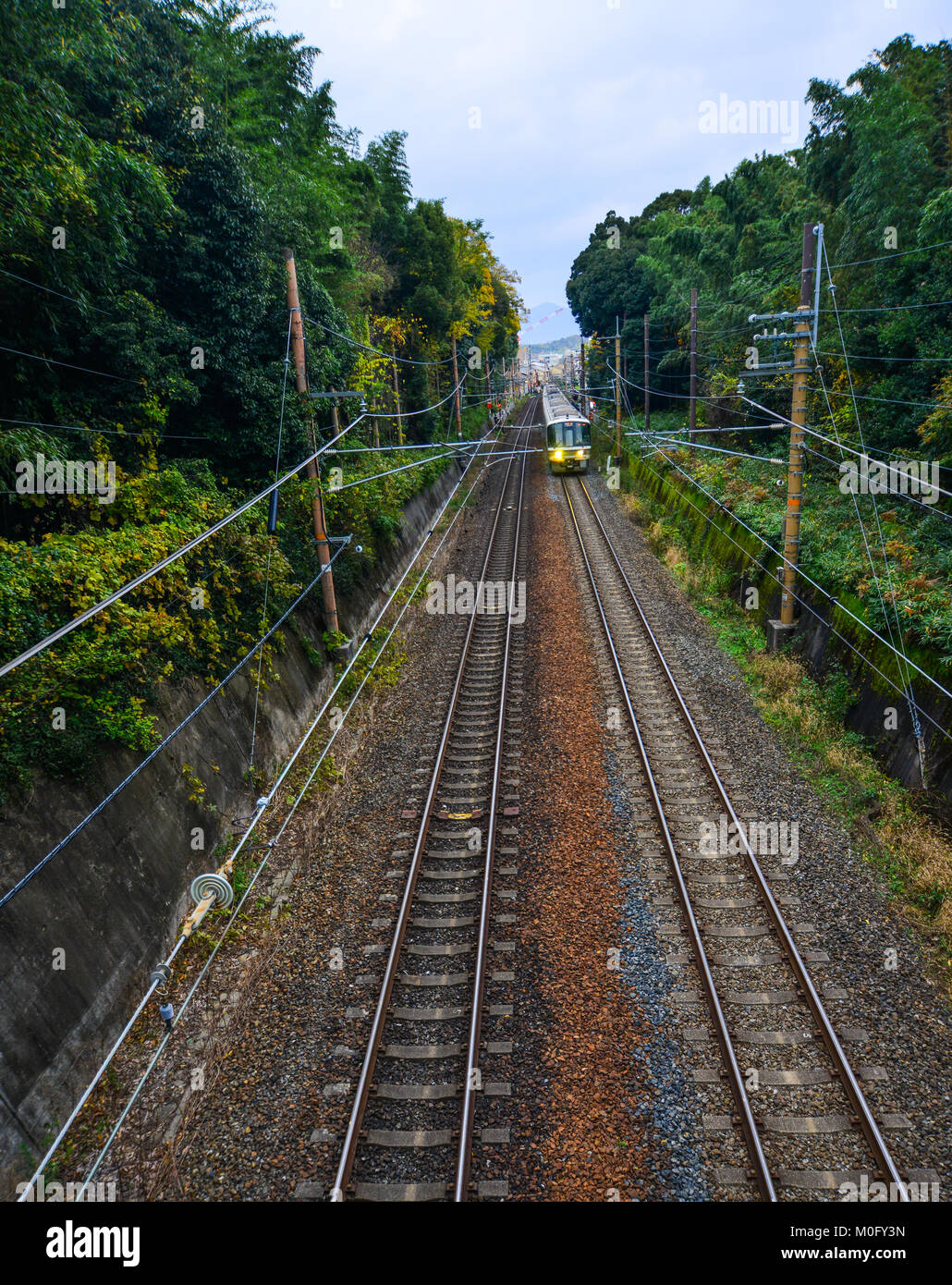 A train running on rail track at countryside in Kyoto, Japan. Rail ...