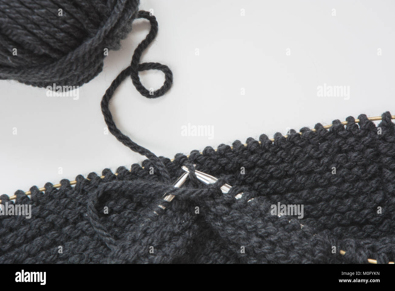 Close-up knitting scarf. Process of knitting. Top view. Copy space ...