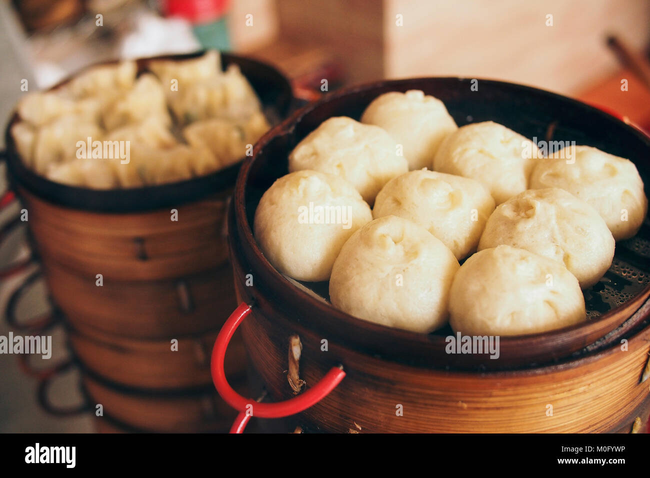 steamed fish balls and prawn dumplings in bamboo basket, dim sum Stock ...