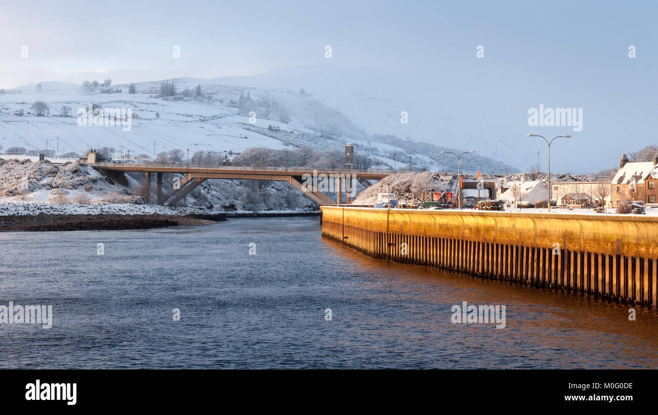 Winter snow lays thick on the breakwaters of Helmsdale Harbour in ...