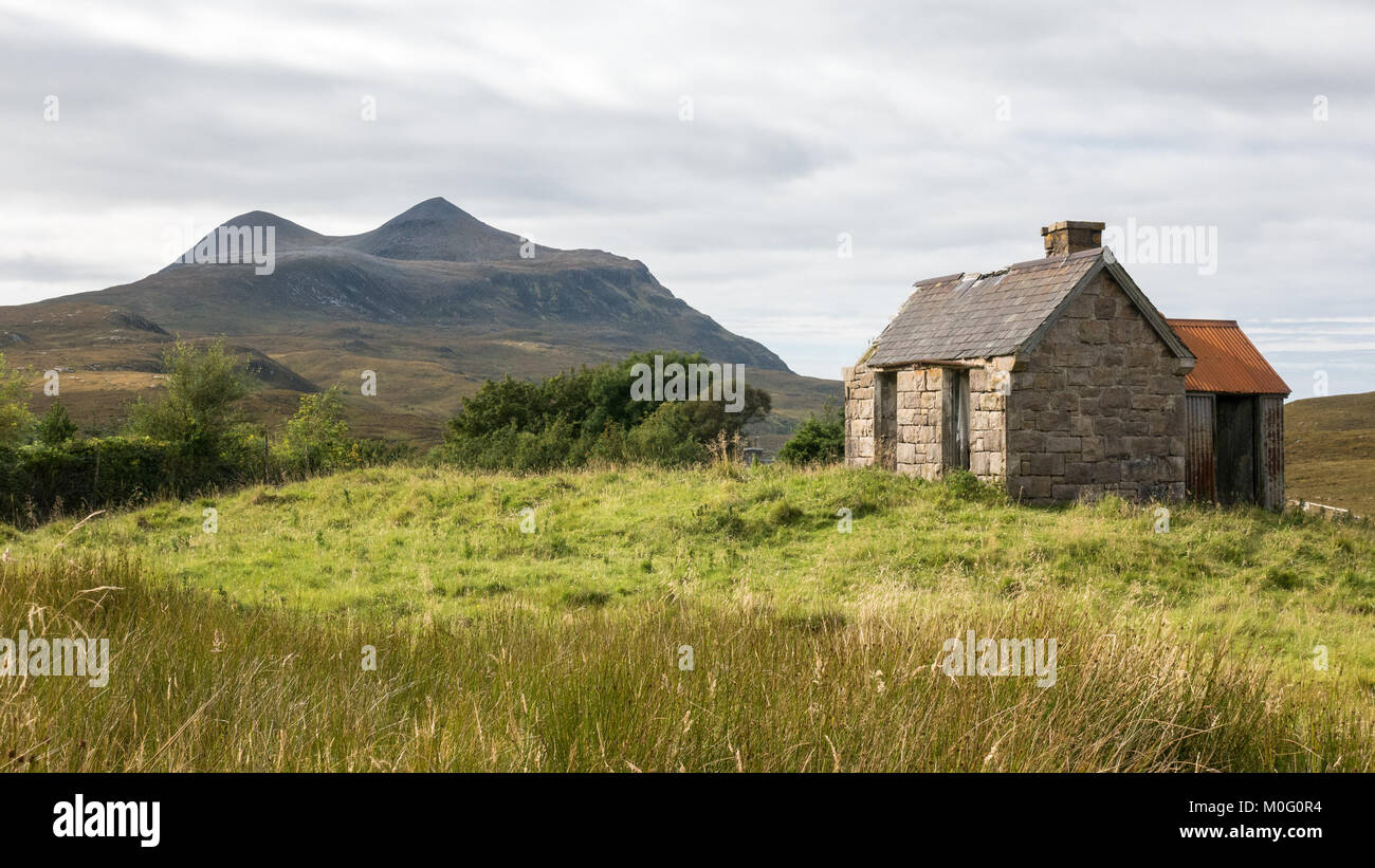 Cul Mor mountain rises behind a barn in the remote village of Elphin in ...
