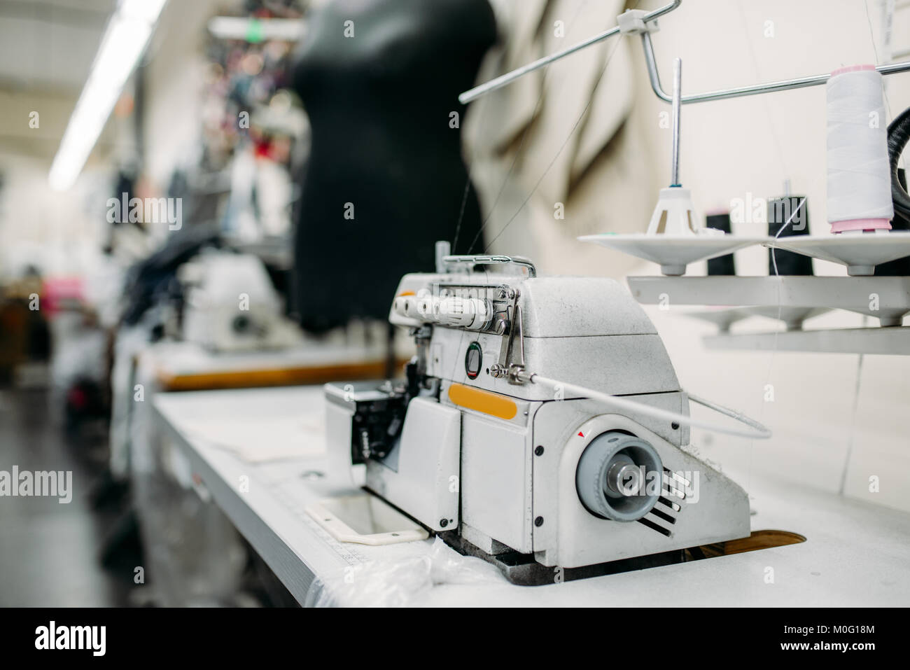 Sewing machine on clothing factory, nobody. Dressmaking industry ...