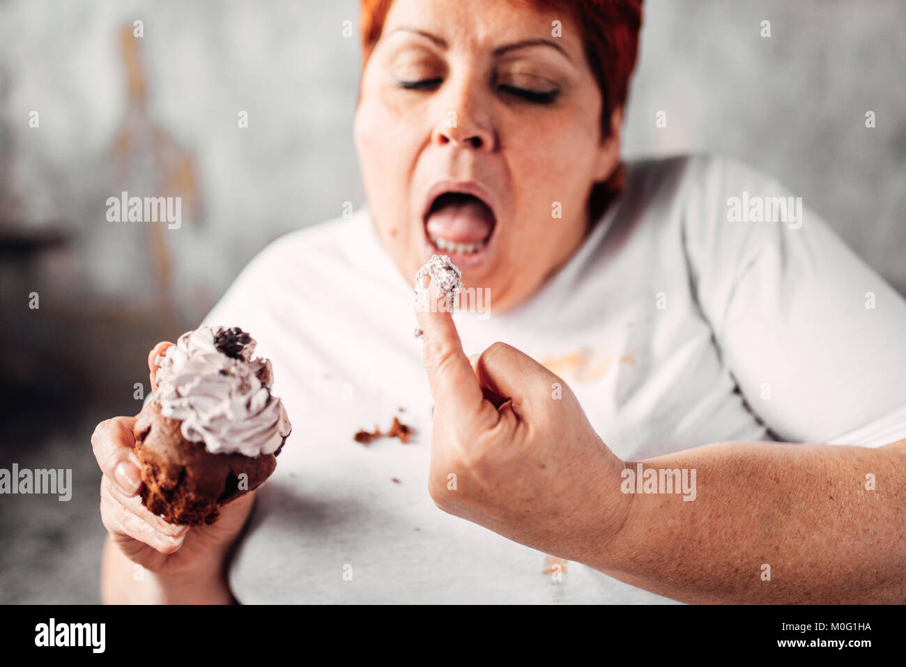 Overweight woman eats sweet cake, laziness and obesity. Unhealthy food ...
