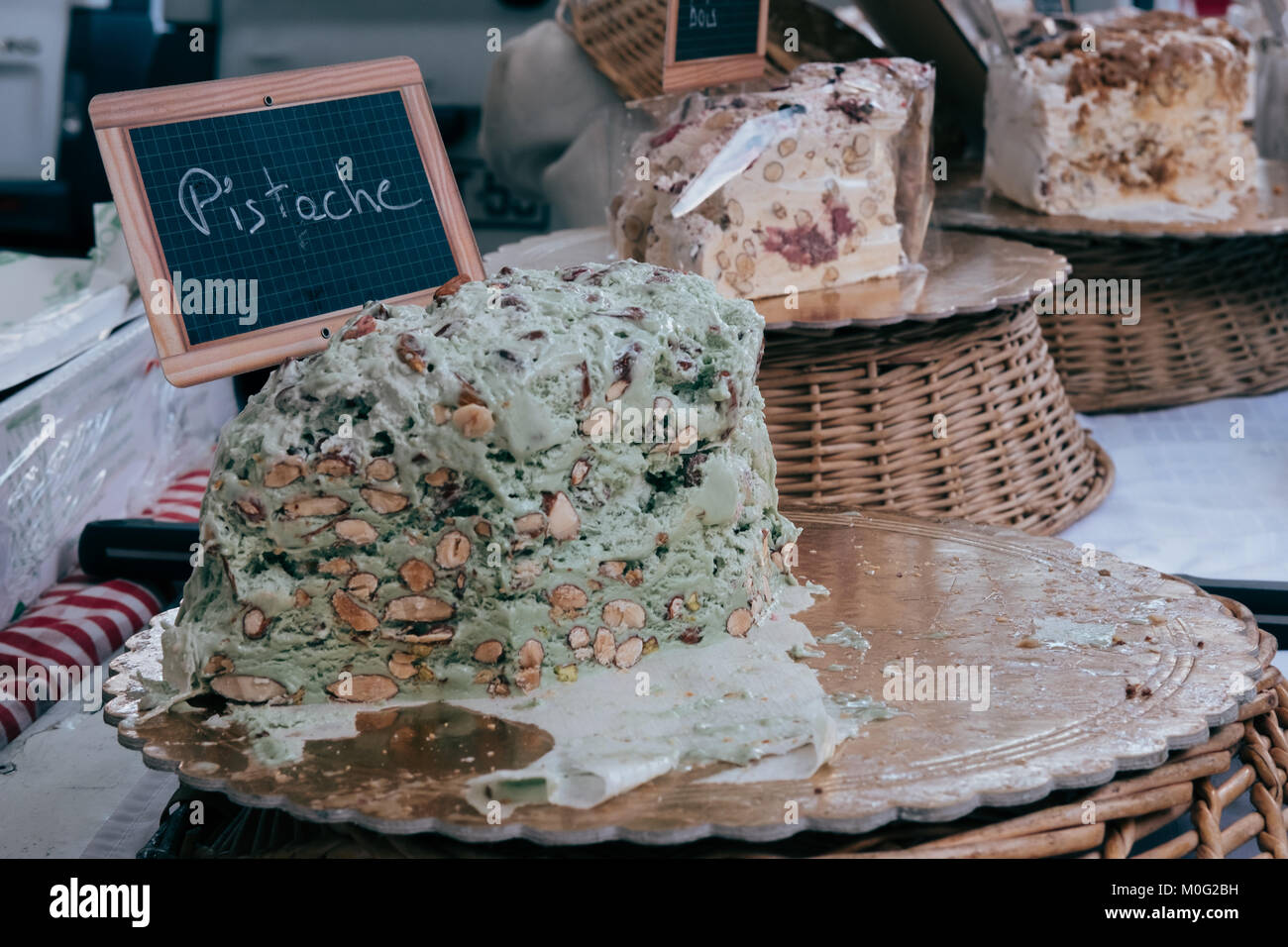 Homemade cake on sale at a market, sliced, on wooden stand Stock Photo ...