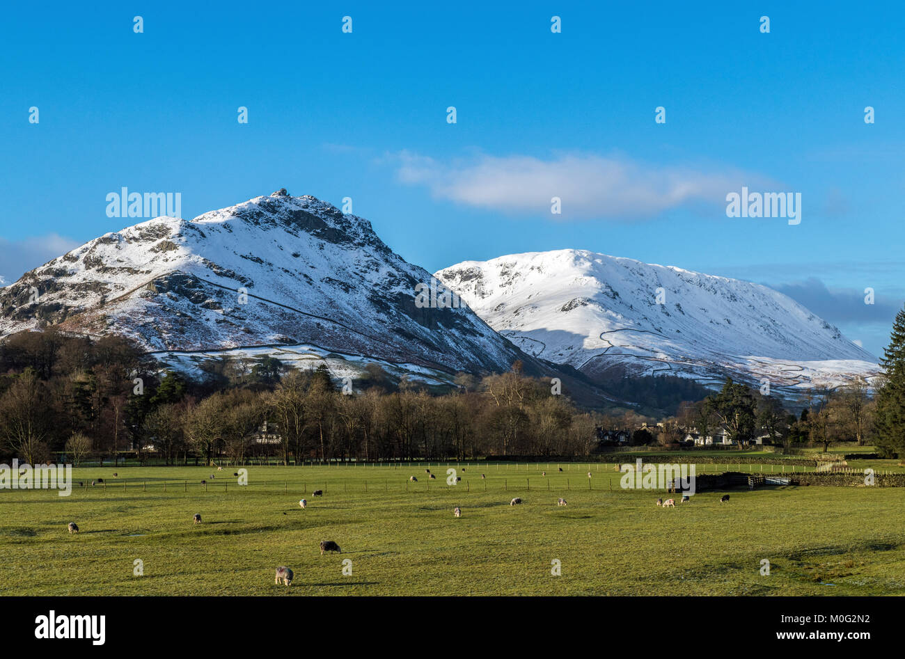 Helm Crag and Steel Fell rising above Grasmere on a bright winter day ...