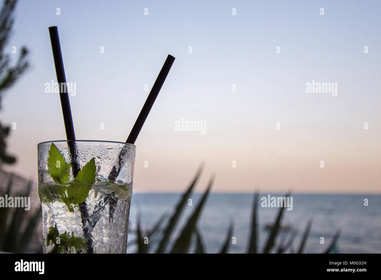 a glass of cocktail on the beach Stock Photo - Alamy