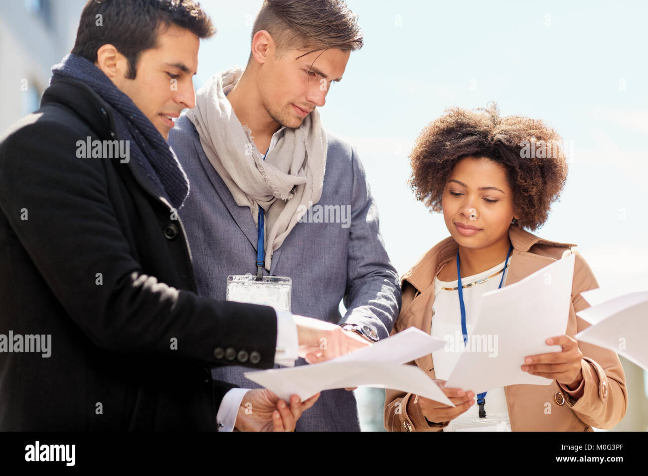 international business team with papers outdoors Stock Photo - Alamy