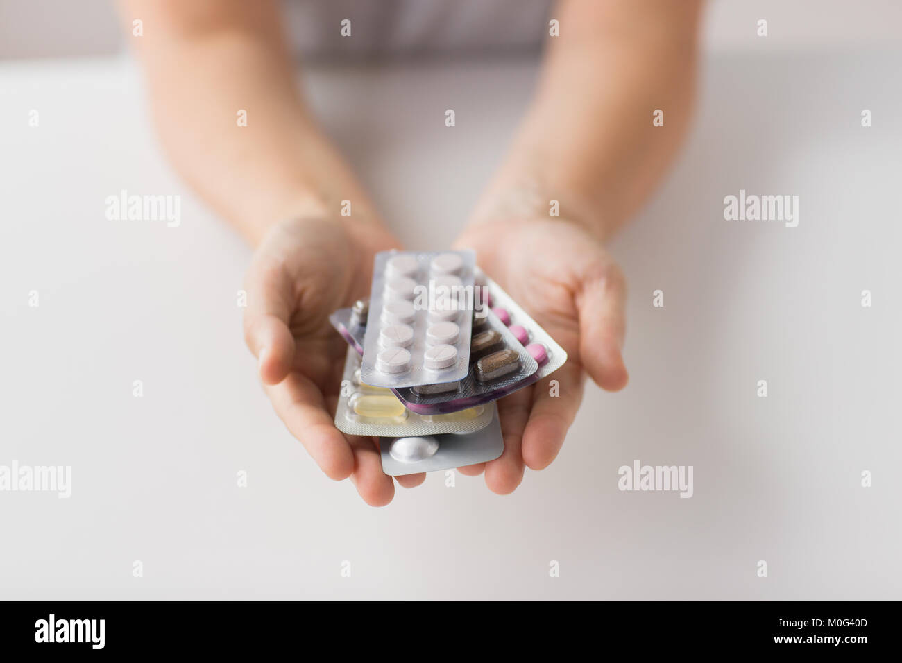 woman hands holding packs of pills Stock Photo - Alamy