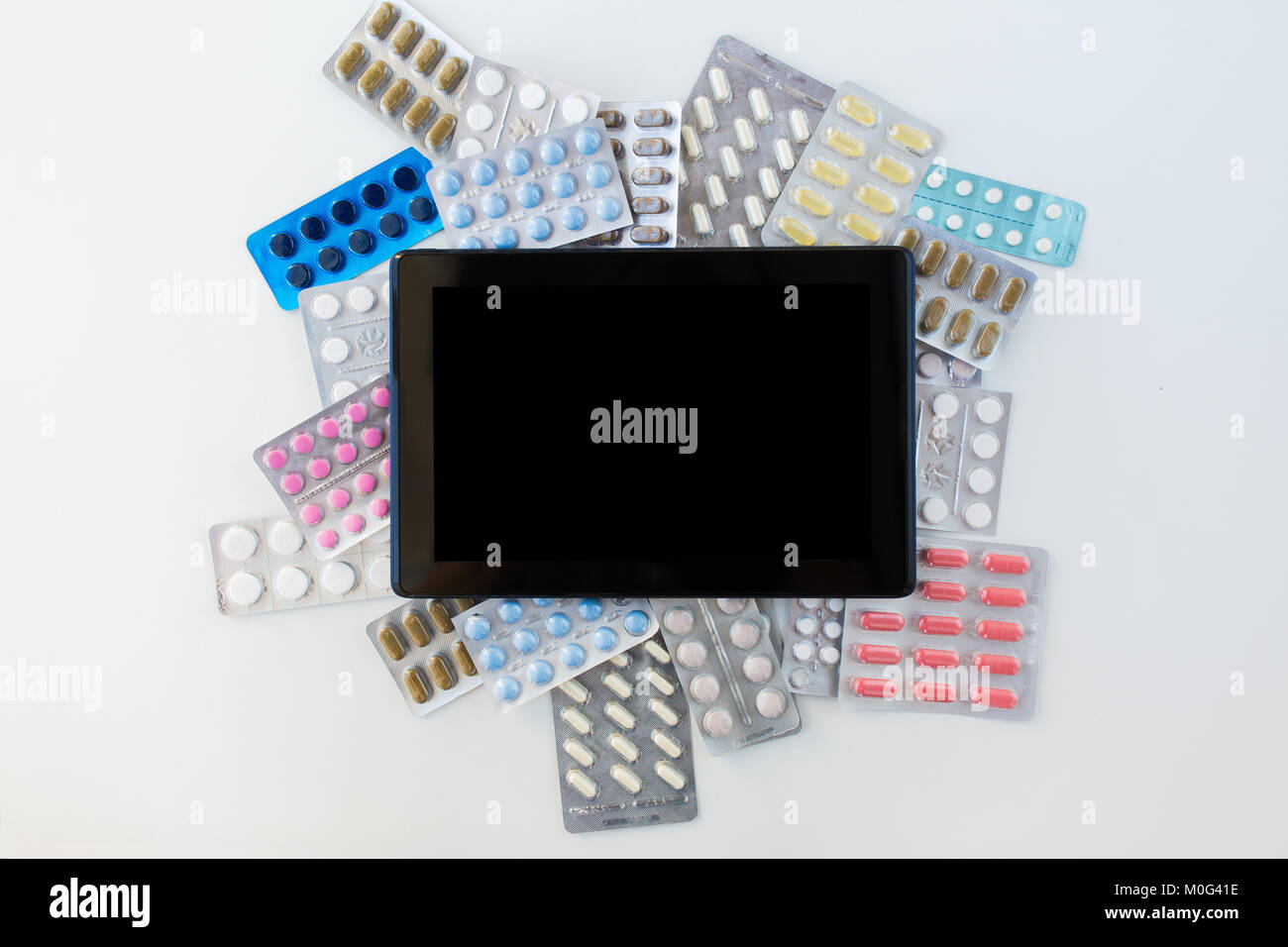 tablet pc with pills and capsules of drugs Stock Photo - Alamy