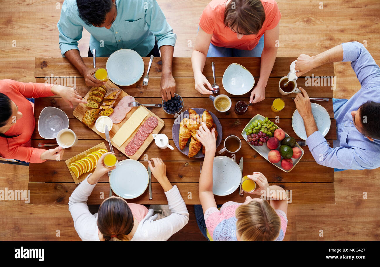 group of people having breakfast at table Stock Photo - Alamy