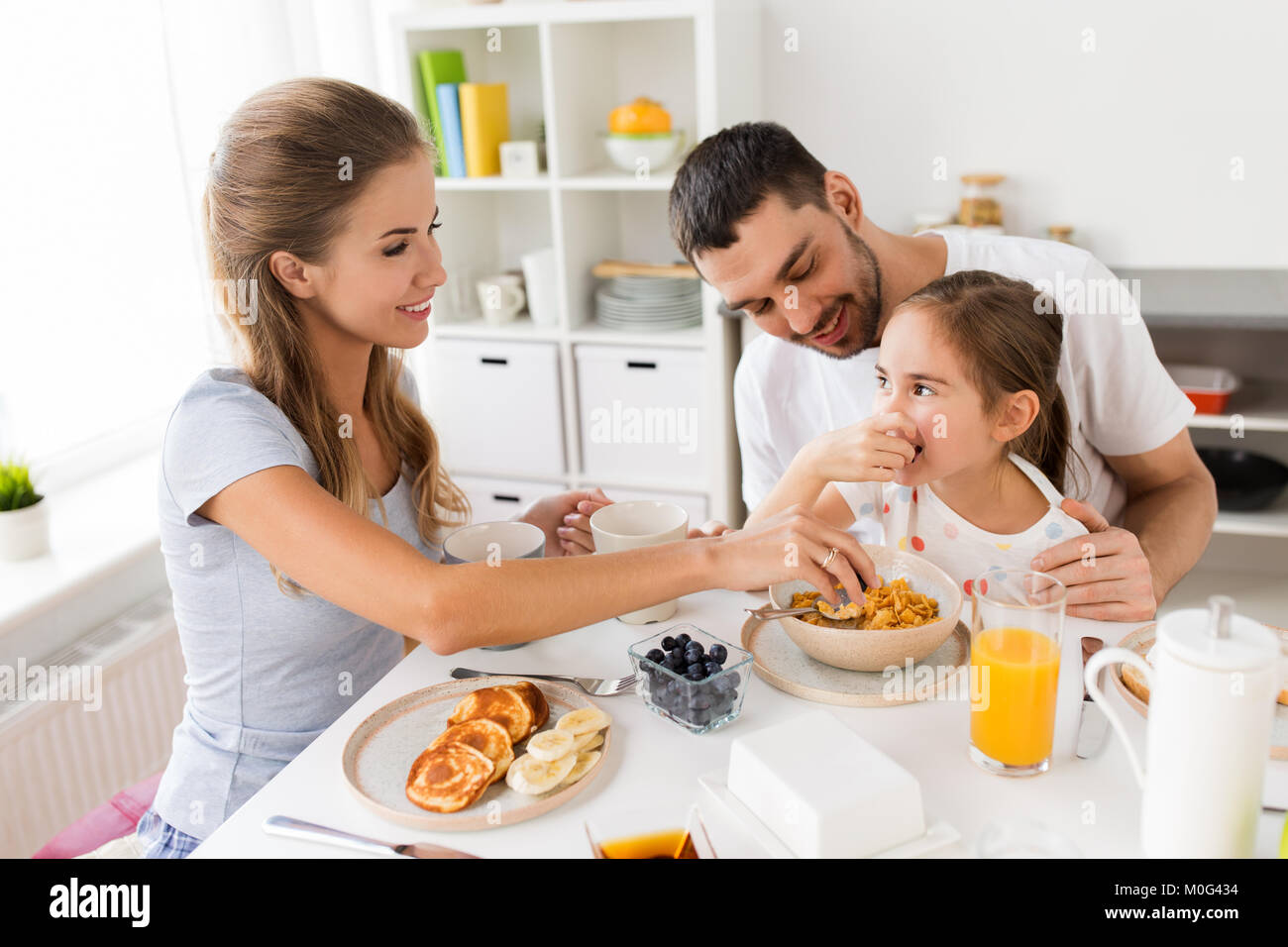 happy family having breakfast at home Stock Photo - Alamy