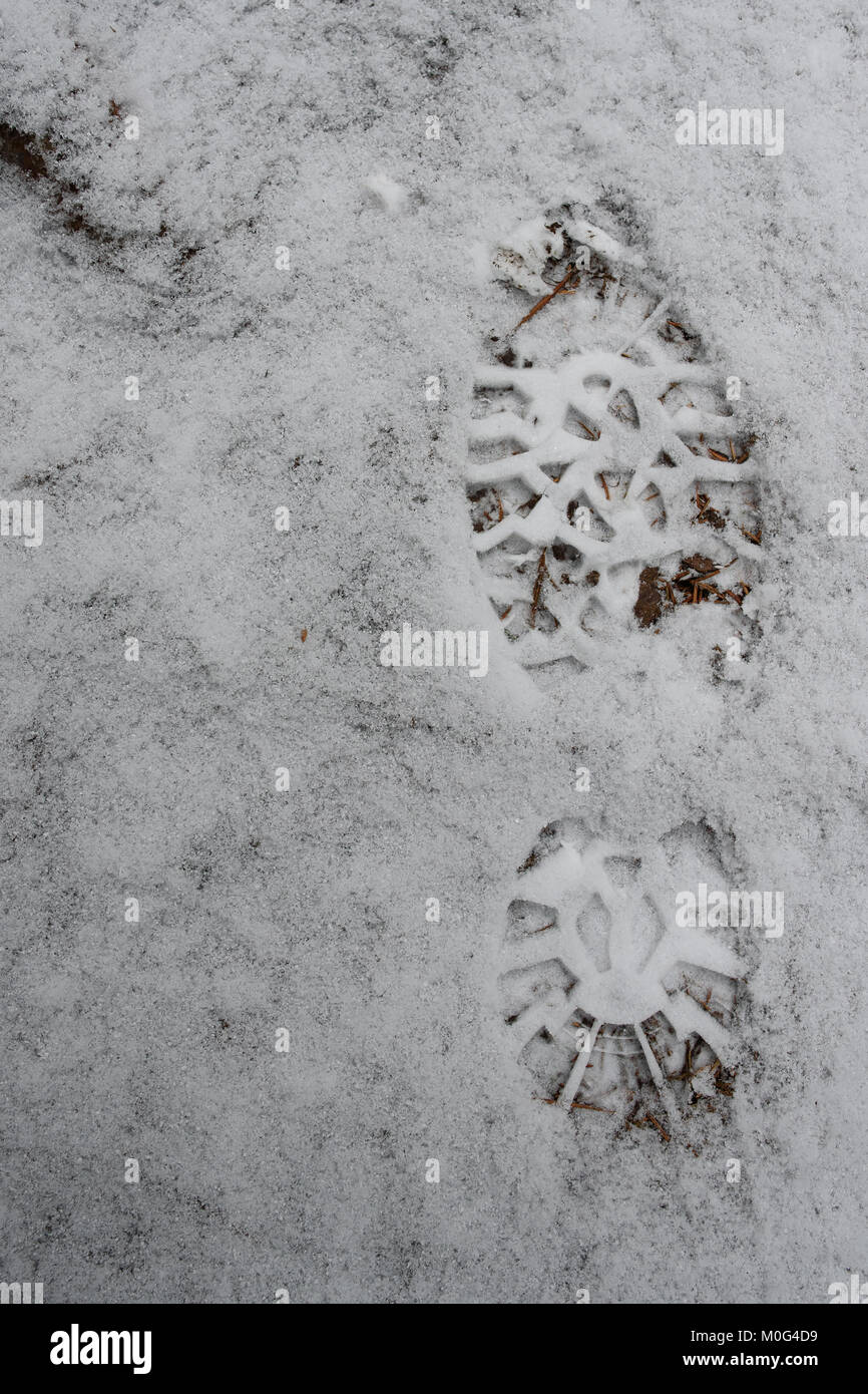 Traces of hiking shoes in the snow. A walk through the fresh air in the ...