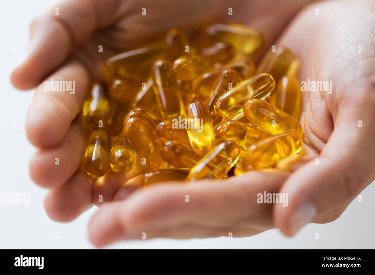 hands holding cod liver oil capsules Stock Photo - Alamy