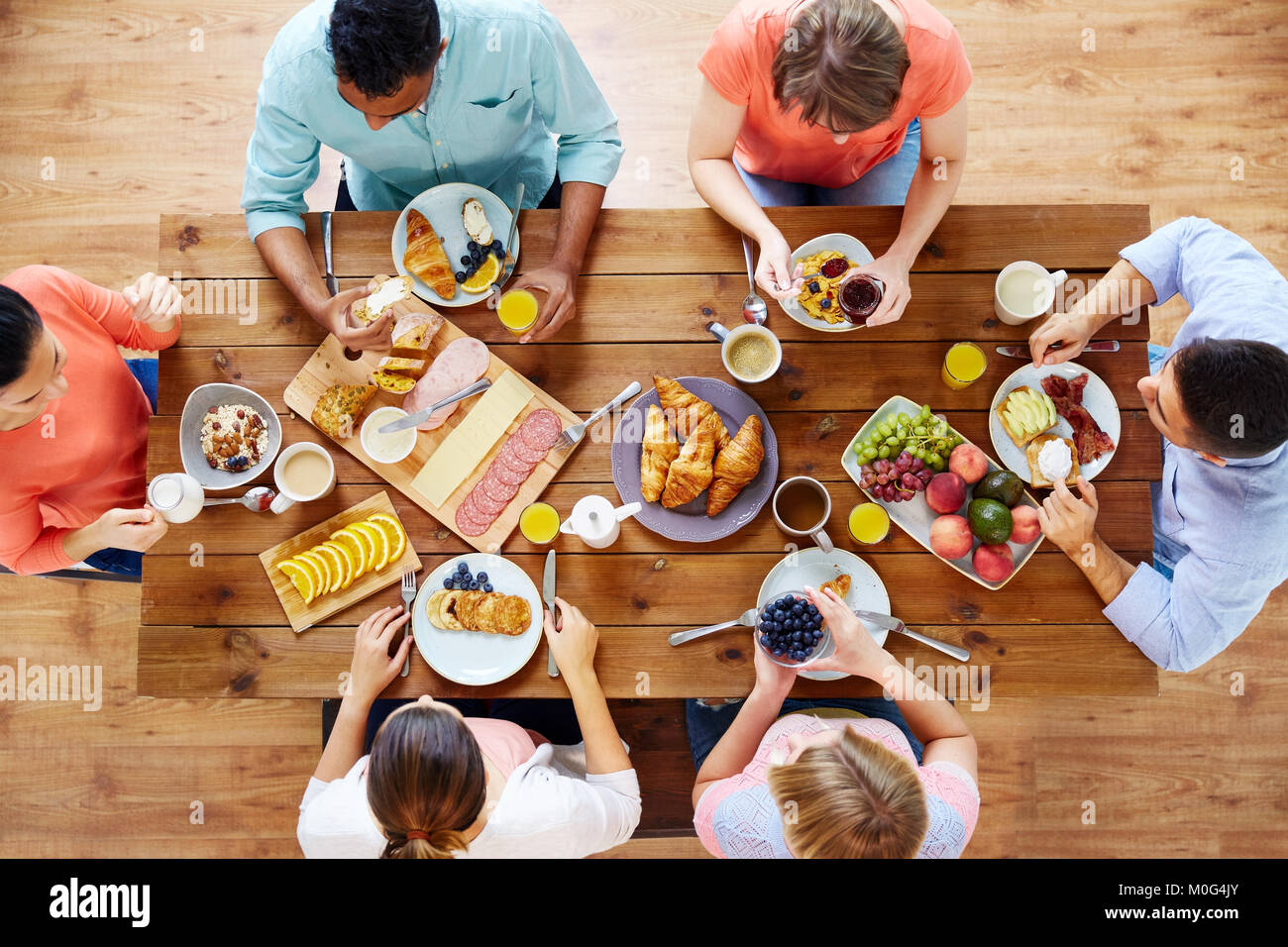 group of people having breakfast at table Stock Photo - Alamy