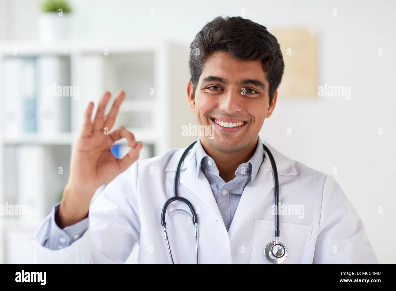 happy doctor with stethoscope at clinic showing ok Stock Photo - Alamy