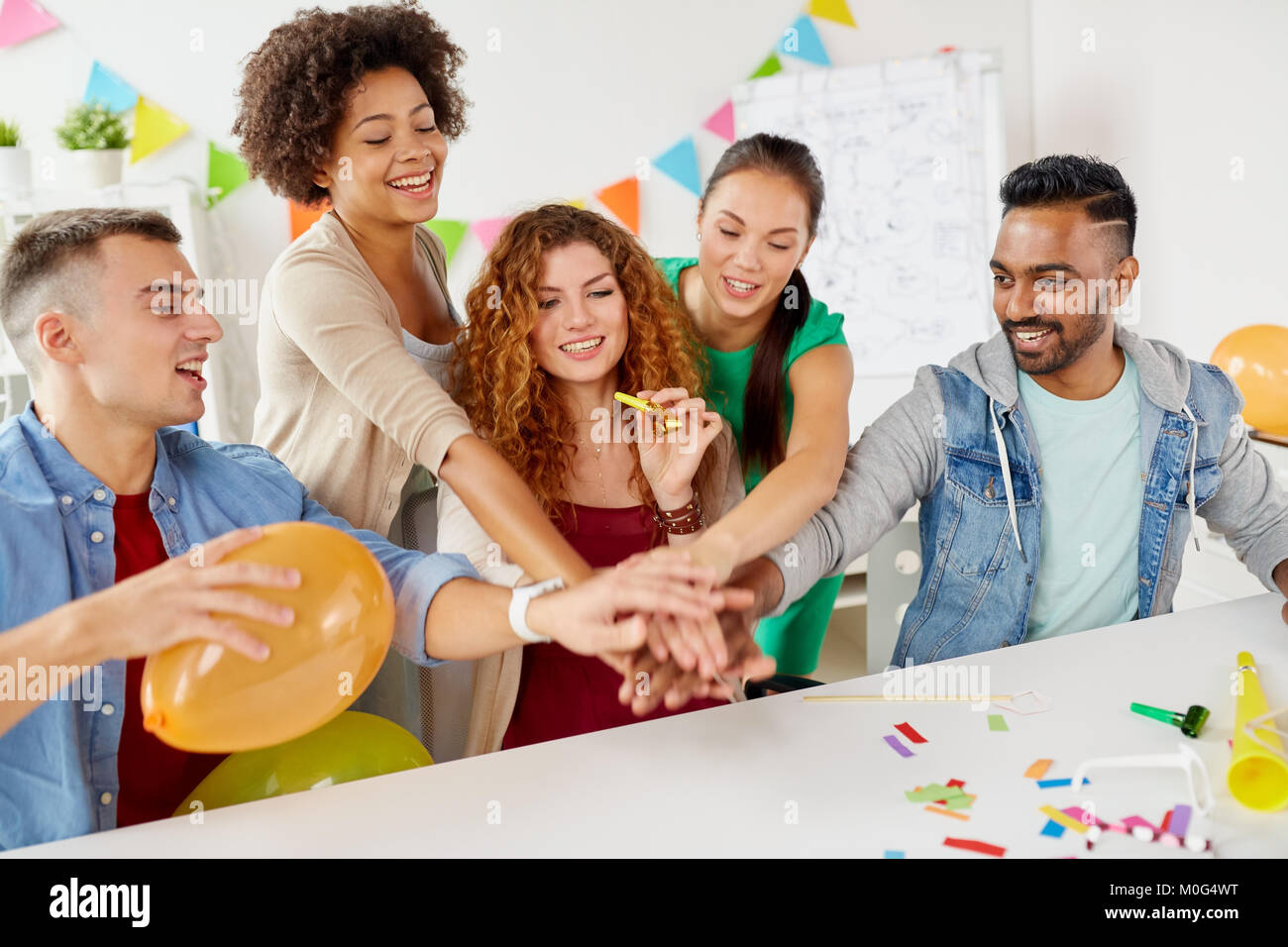 happy business team at office party holding hands Stock Photo - Alamy