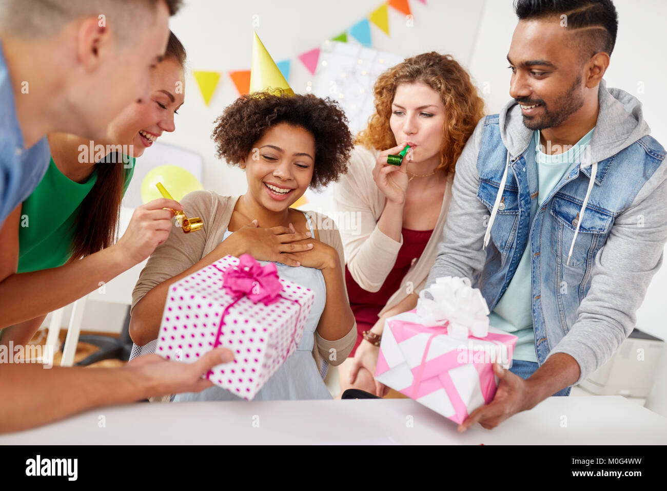 team greeting colleague at office birthday party Stock Photo - Alamy