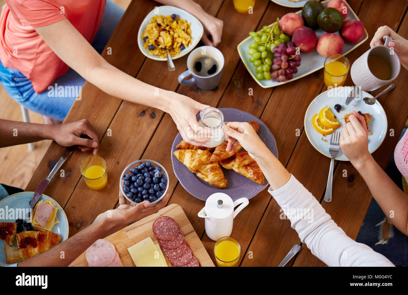 people having breakfast at table with food Stock Photo - Alamy