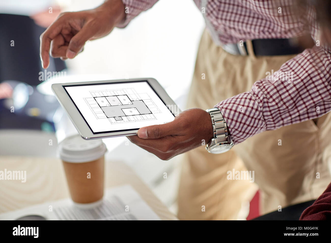 architector with blueprint on tablet pc at office Stock Photo - Alamy
