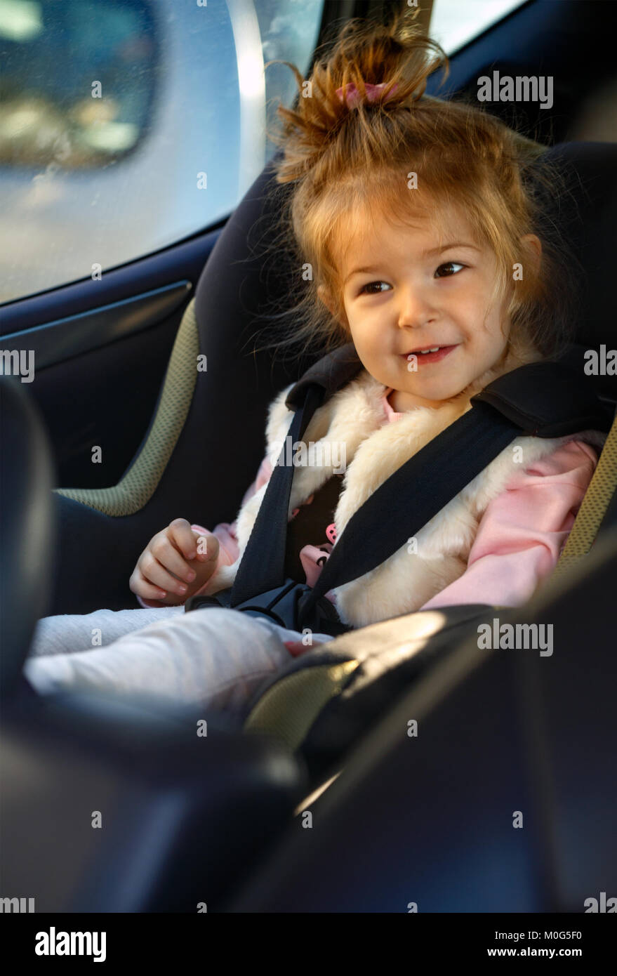 family, transport, road trip concept - smiling child sitting in the car ...