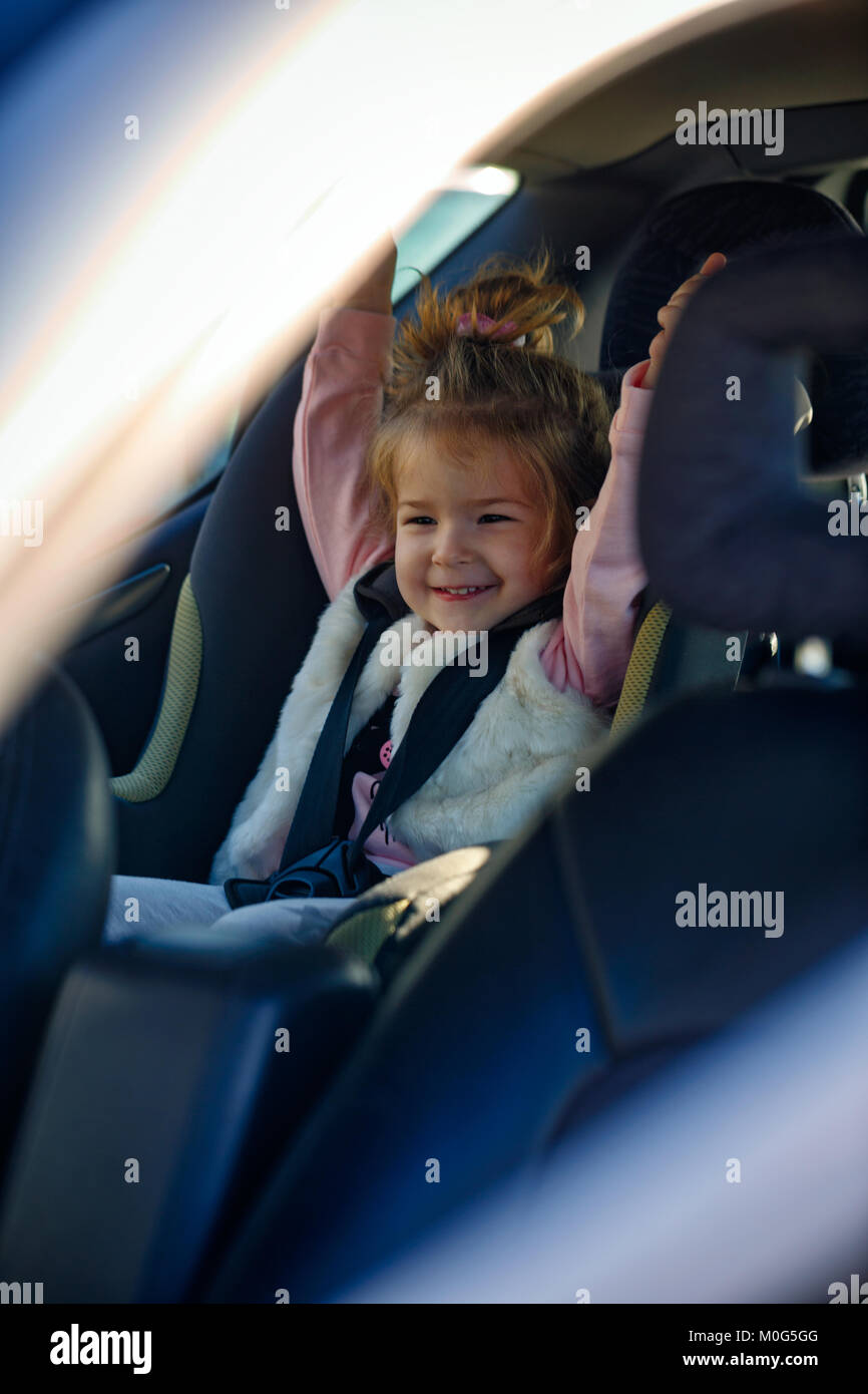 happy toddler girl in her car seat Stock Photo - Alamy