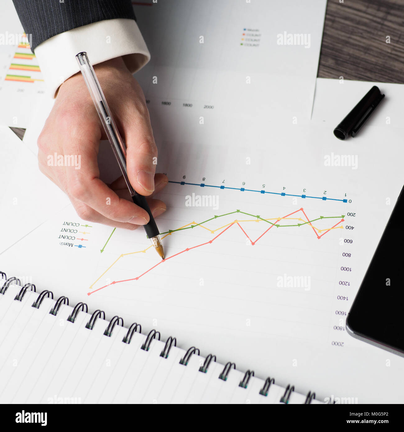 Business man checking bar chart Stock Photo - Alamy