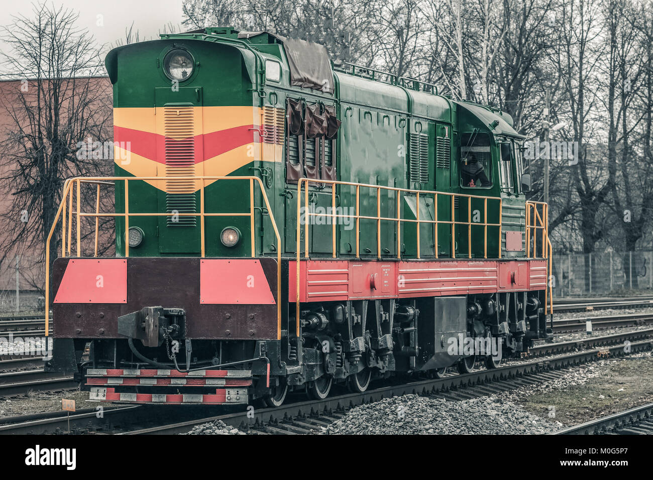 Green diesel cargo locomotive. Freight train in action Stock Photo - Alamy
