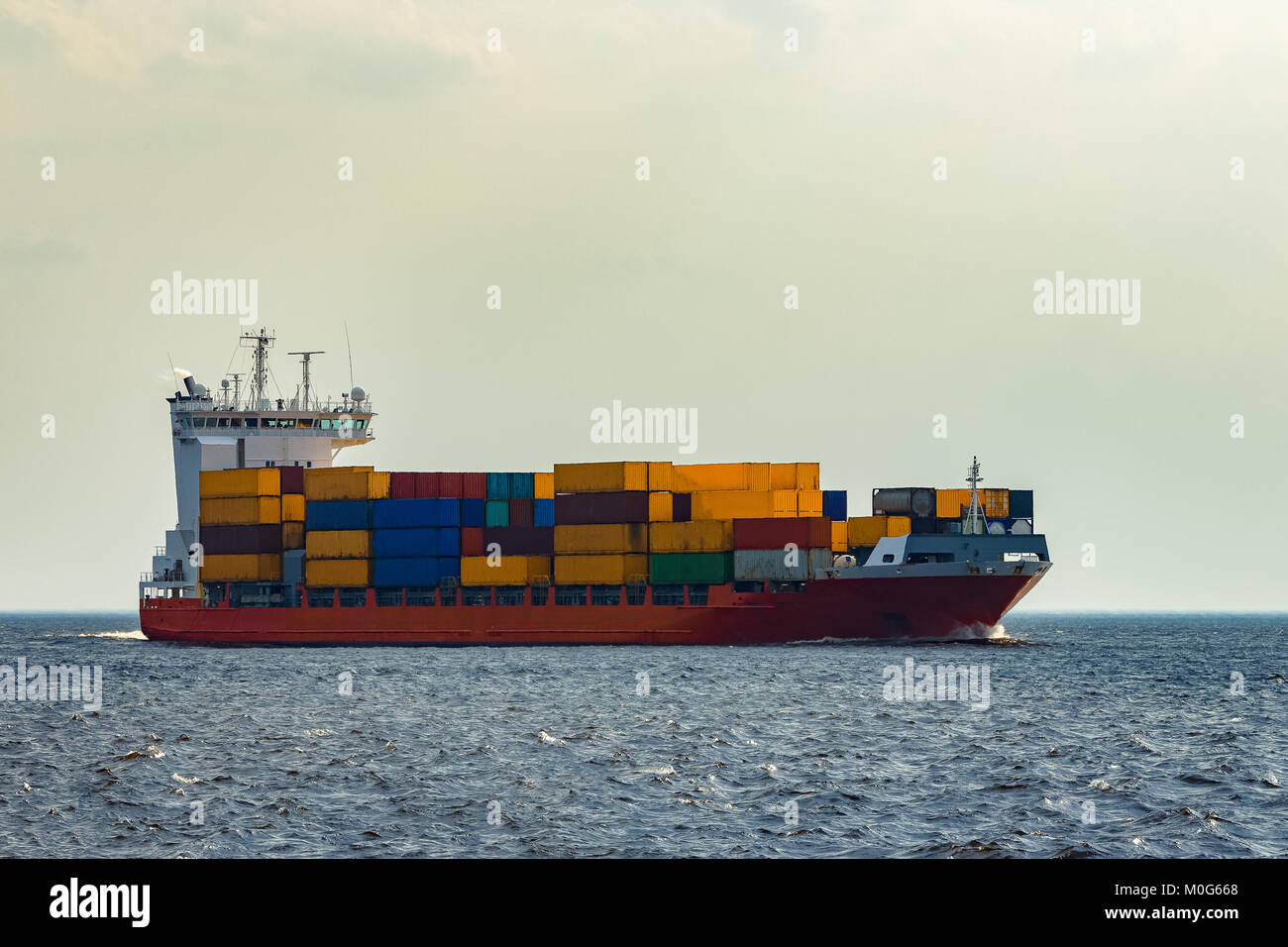 Red container ship. Logistics and production transfer Stock Photo - Alamy