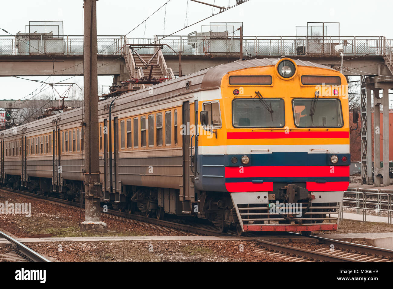 Old yellow passenger electric train driving at the terminal Stock Photo ...