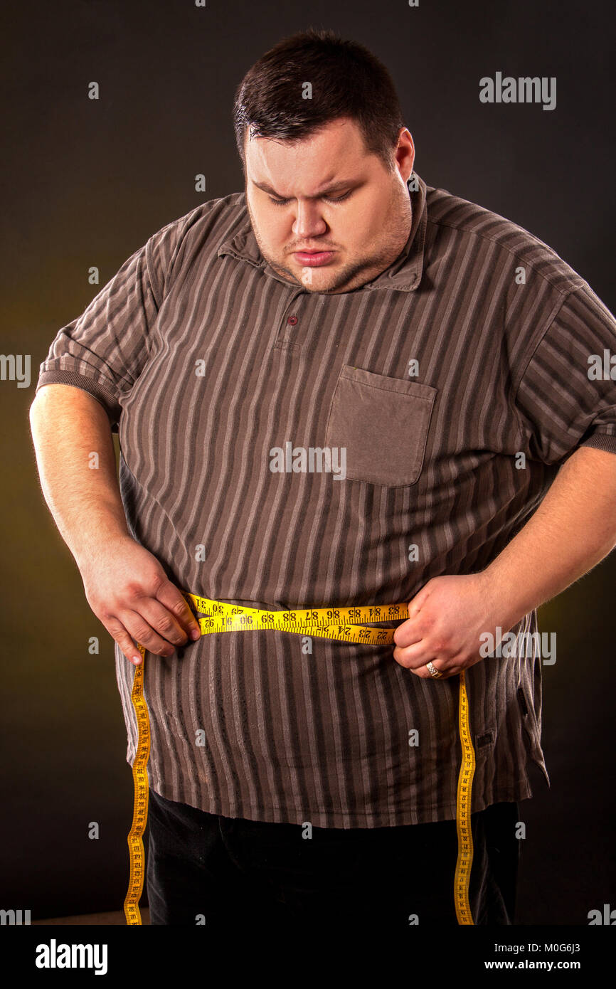 Overweight boy tape measure hi-res stock photography and images - Alamy
