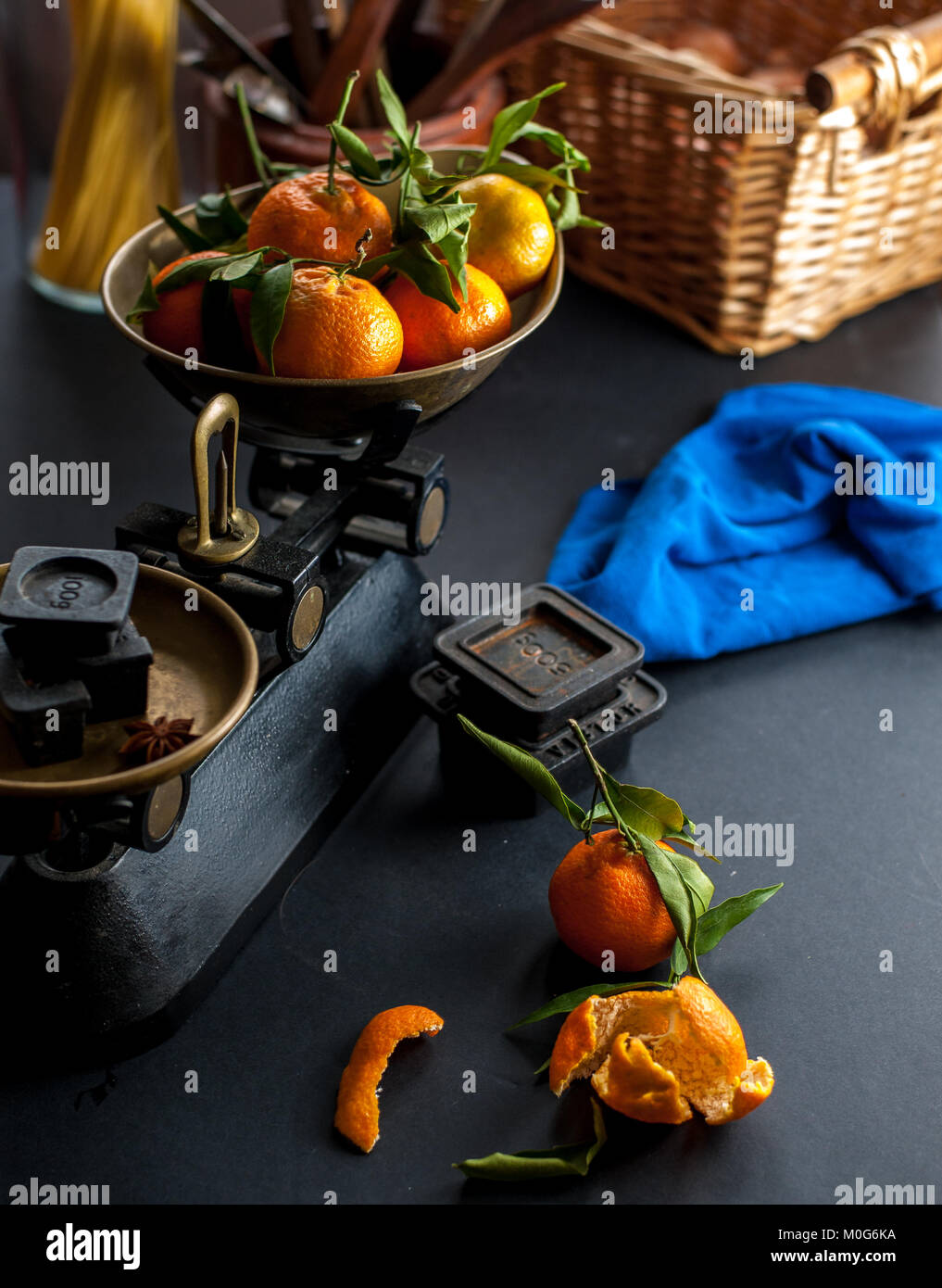 Fresh whole clementines with green leaves in vintage scale and one ...