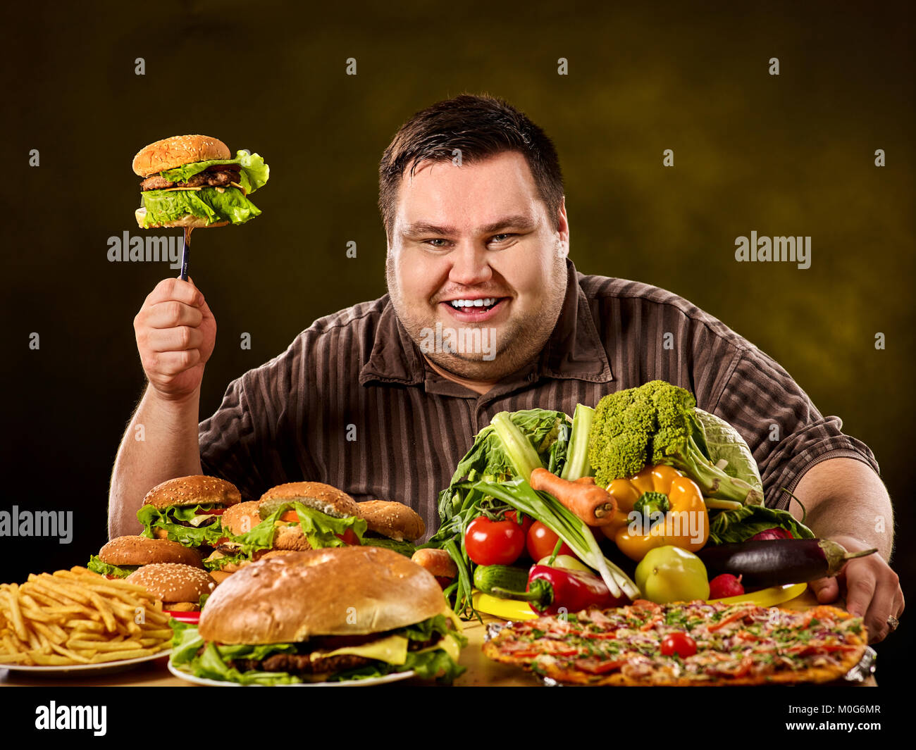 Obese woman eating hamburger hi-res stock photography and images - Alamy