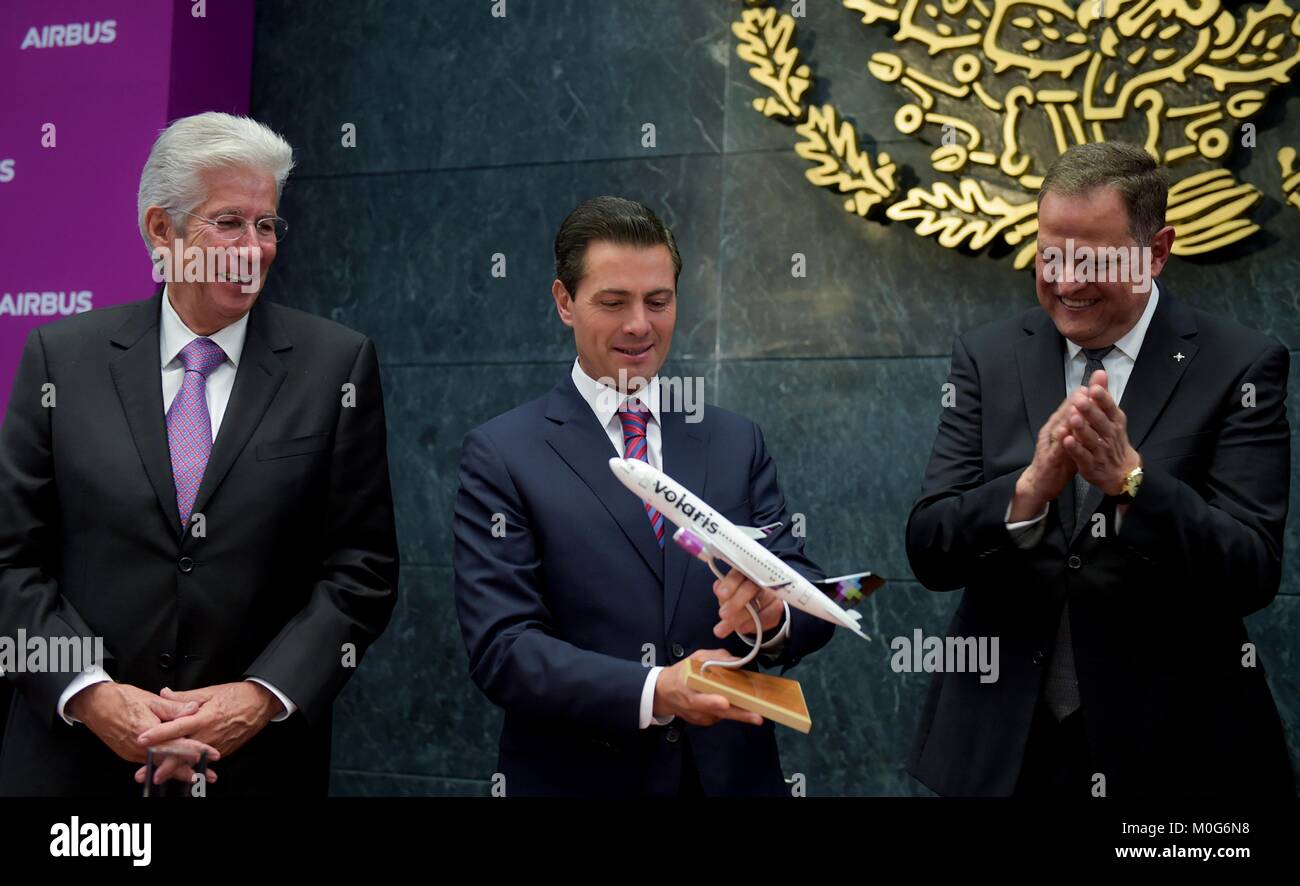 Mexican President Enrique Pena Nieto, center, holds a model Airbus ...