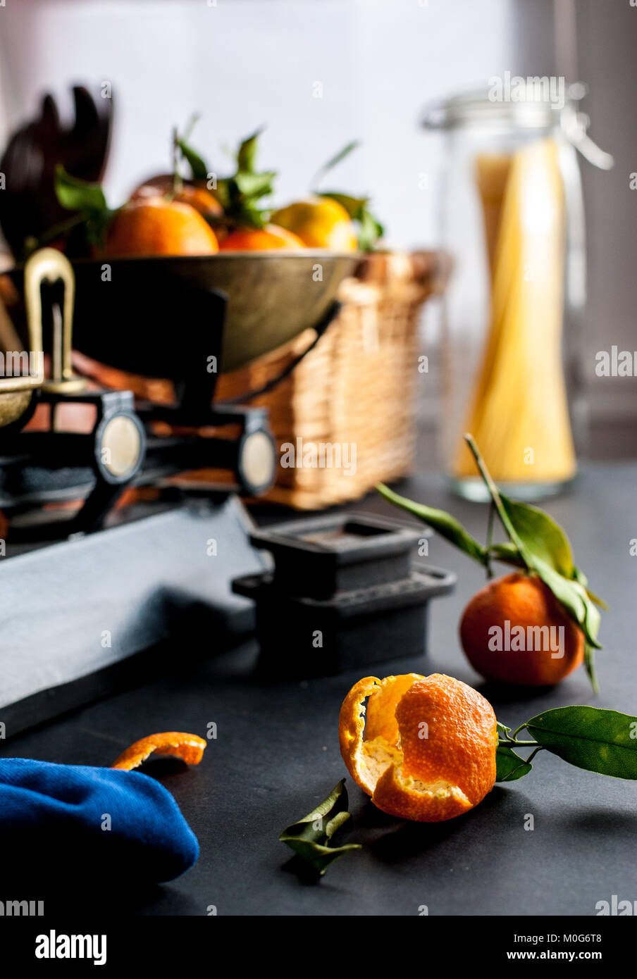 Fresh whole clementines with green leaves in vintage scale and one ...