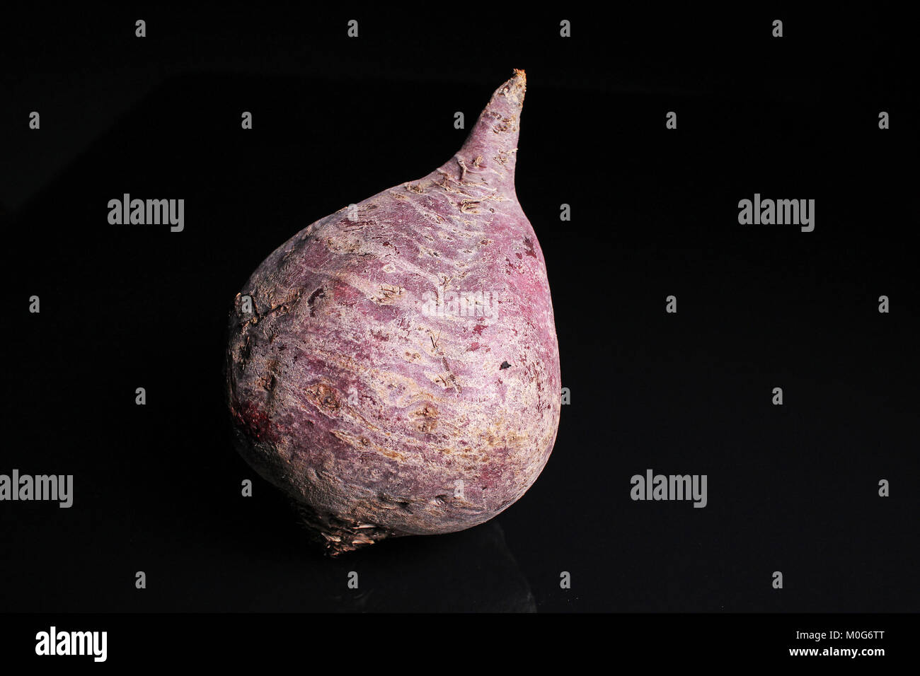 Beet beetroot. Whole and half cutted beet beetroot on black reflective ...