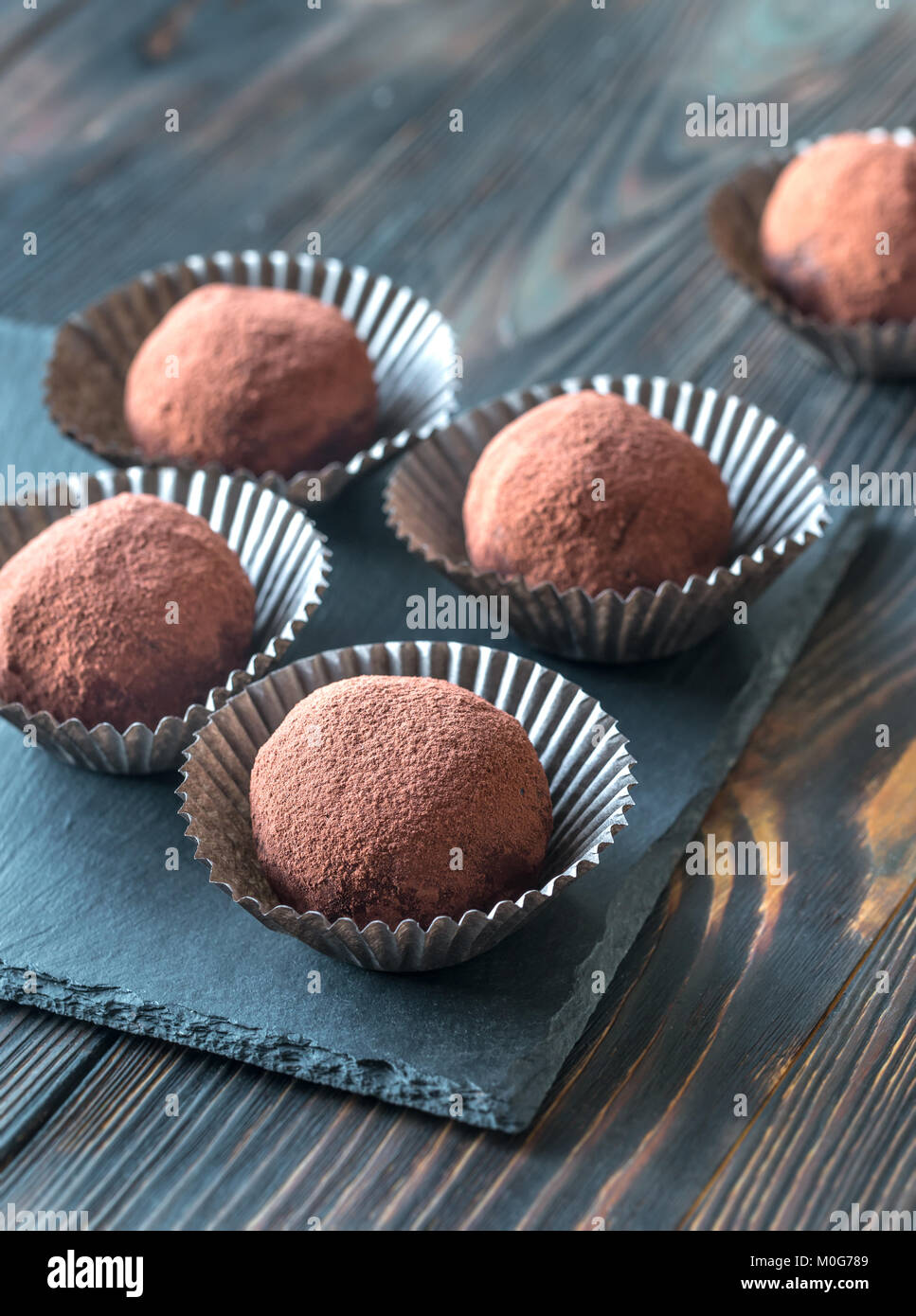 Rum balls on the black stone board Stock Photo - Alamy