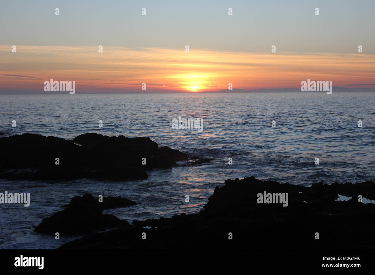 A sunset over Laguna beach. A waterfront sunset at Laguna Beach Stock ...