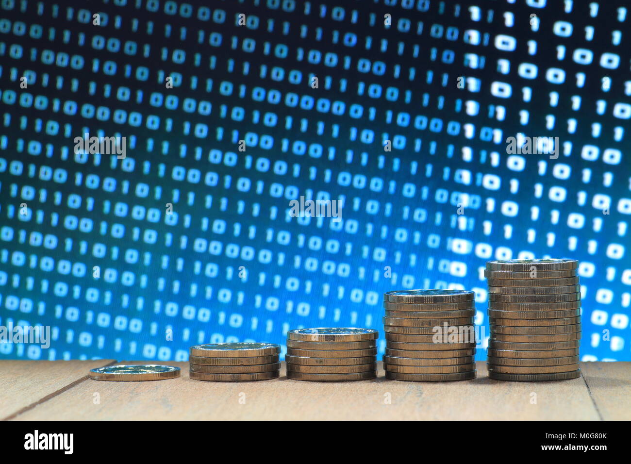 Digital economy. Coin stack with blue binary digital numbers background ...