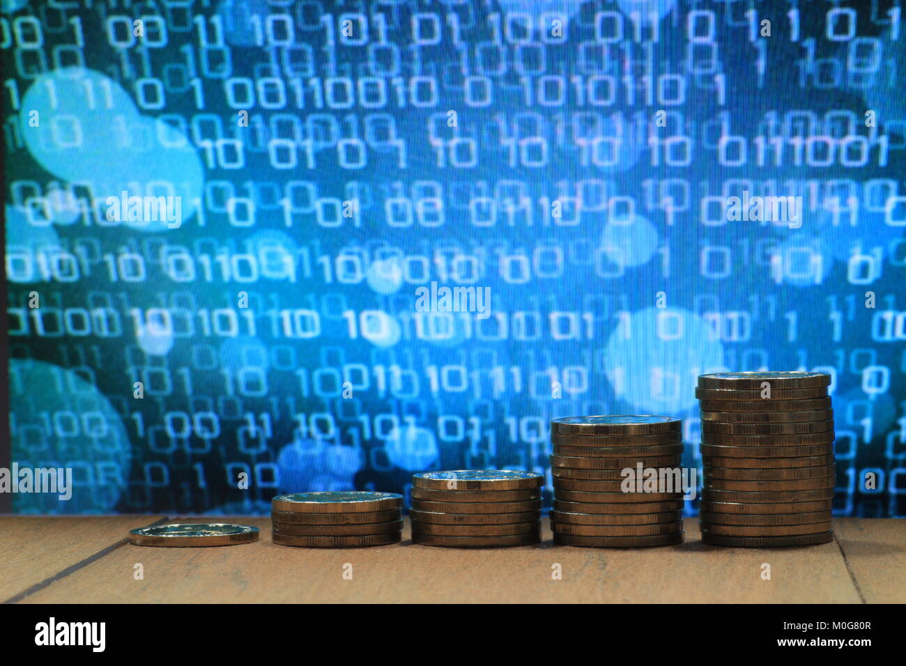 Digital economy. Coin stack with blue binary digital numbers background ...