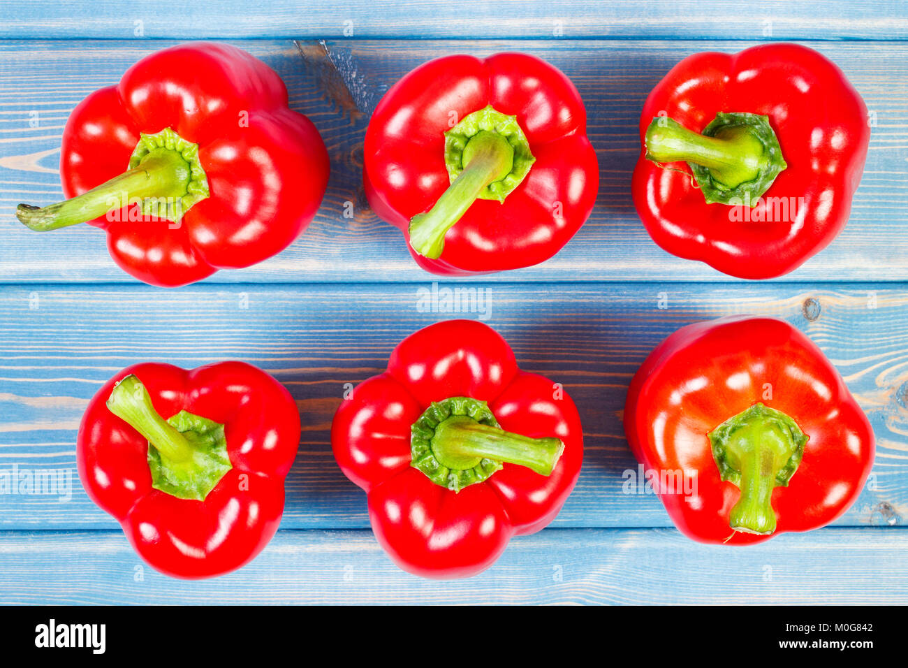 View from above on fresh red peppers on blue boards, concept of healthy ...