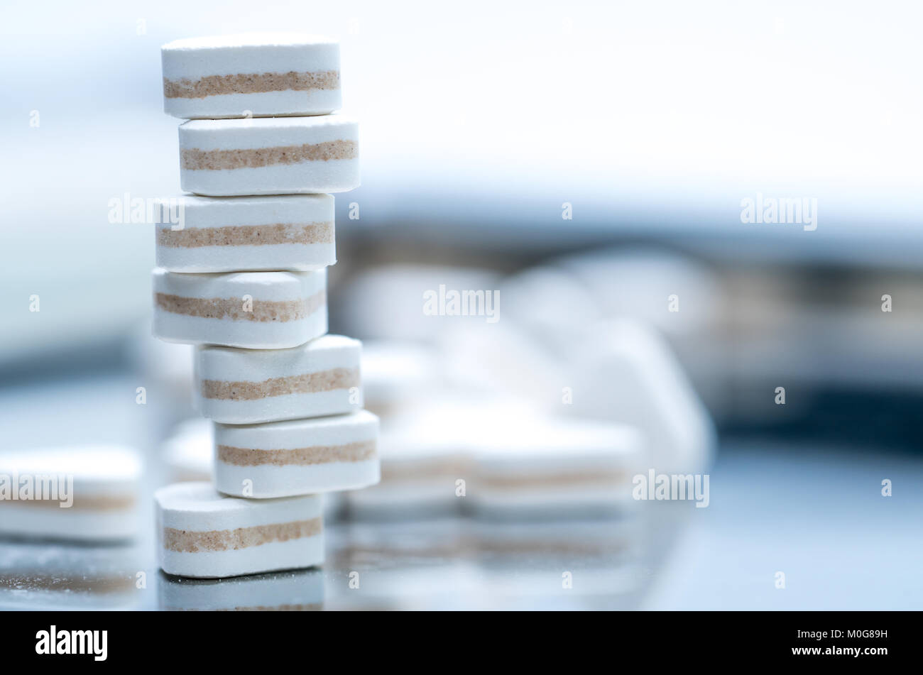 Macro shot of triangle shape tablet pills. Three layers tablet pills ...