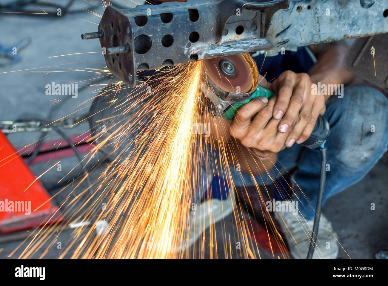 Electric wheel grinding on chassis of a car - auto body repair shop ...