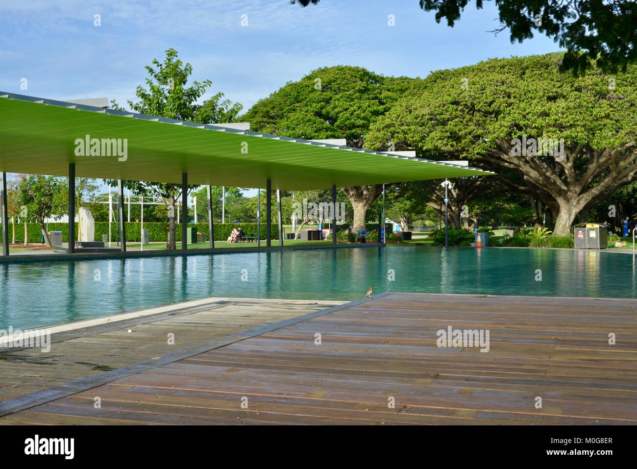Large public pool with overhanging shading hi-res stock photography and ...