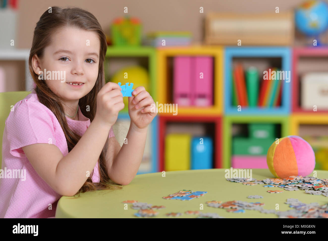 girl collecting puzzles Stock Photo - Alamy
