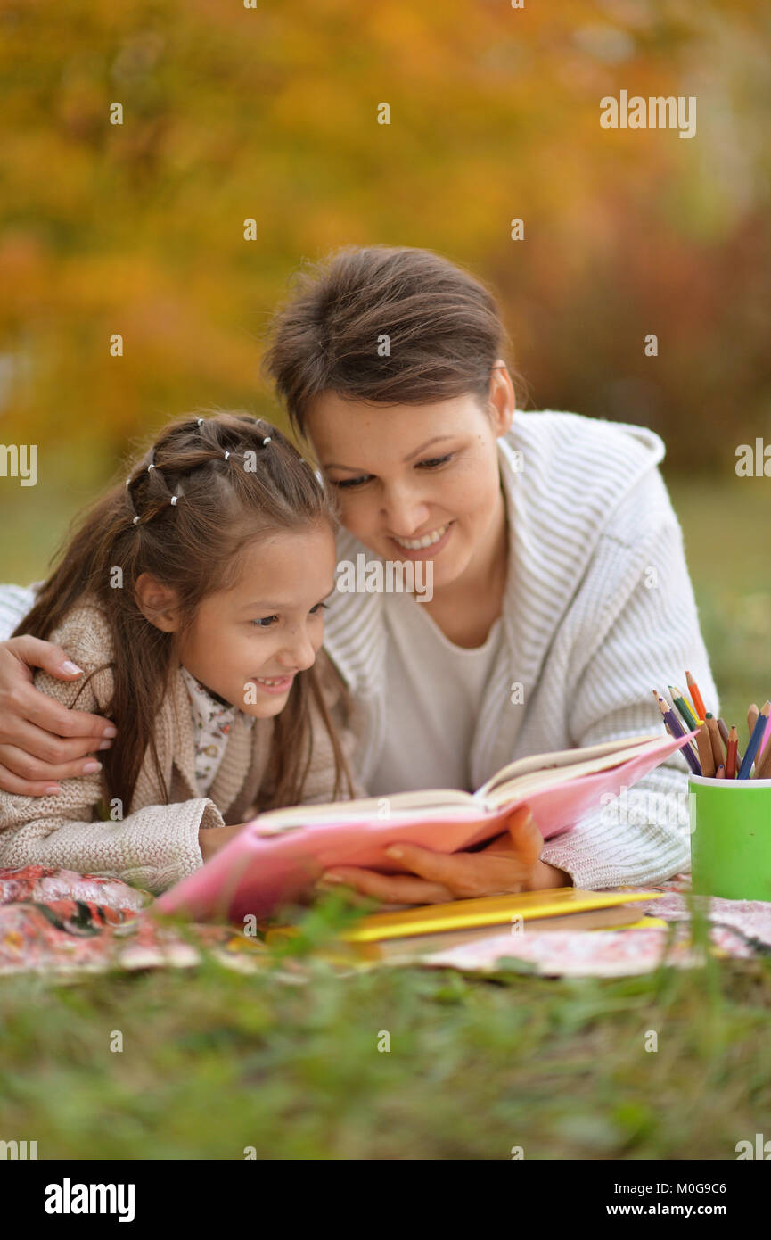 girl with mother reading Stock Photo - Alamy