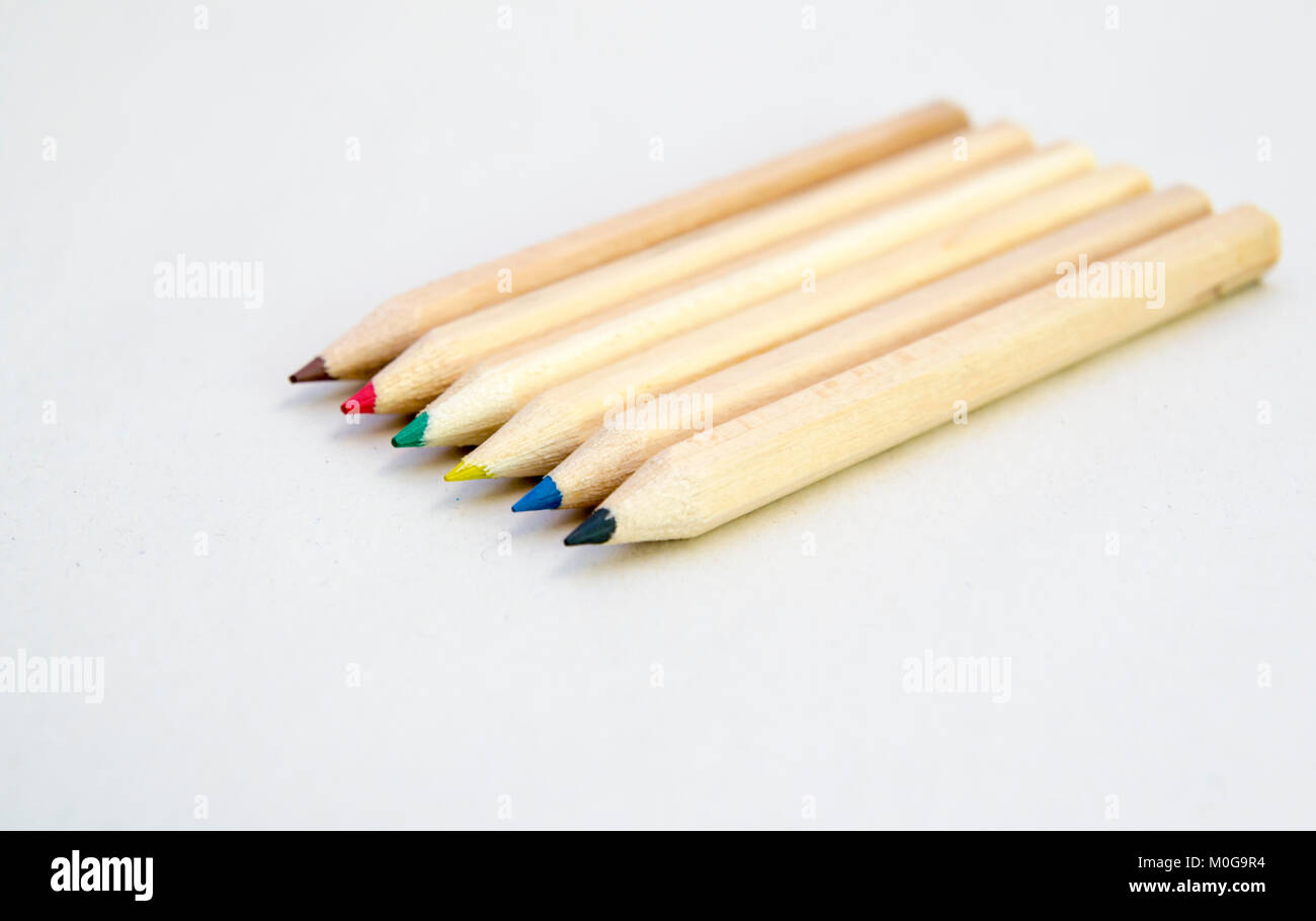 Six wood colored crayons on white background Stock Photo - Alamy
